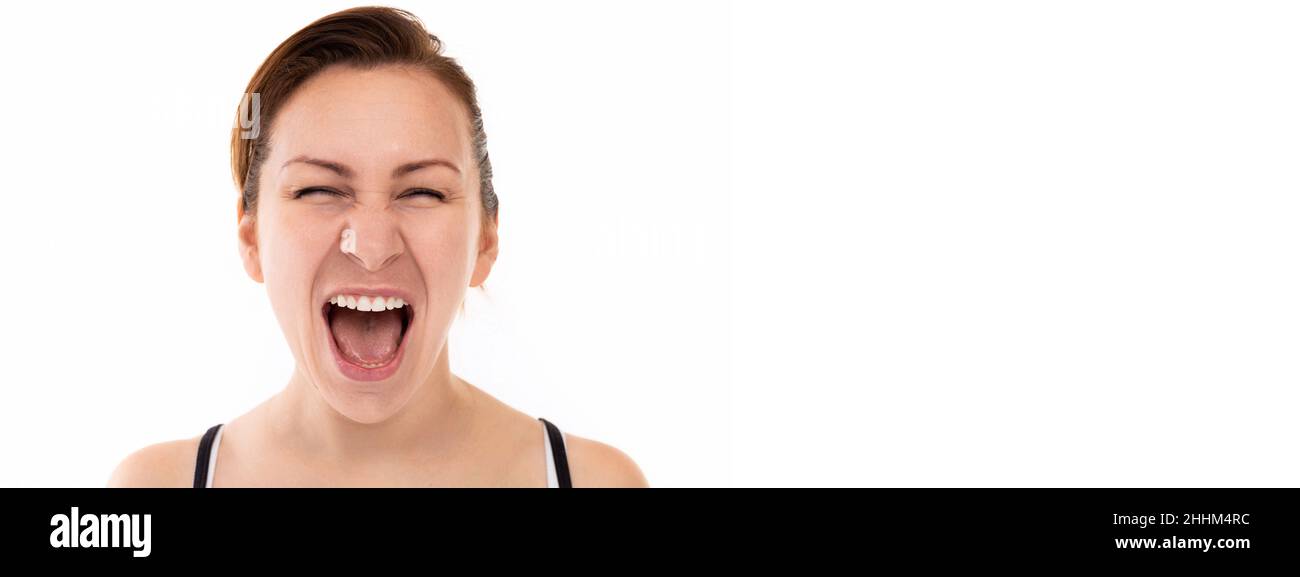 young woman smiling with teeth screaming loudly with her mouth wide ...