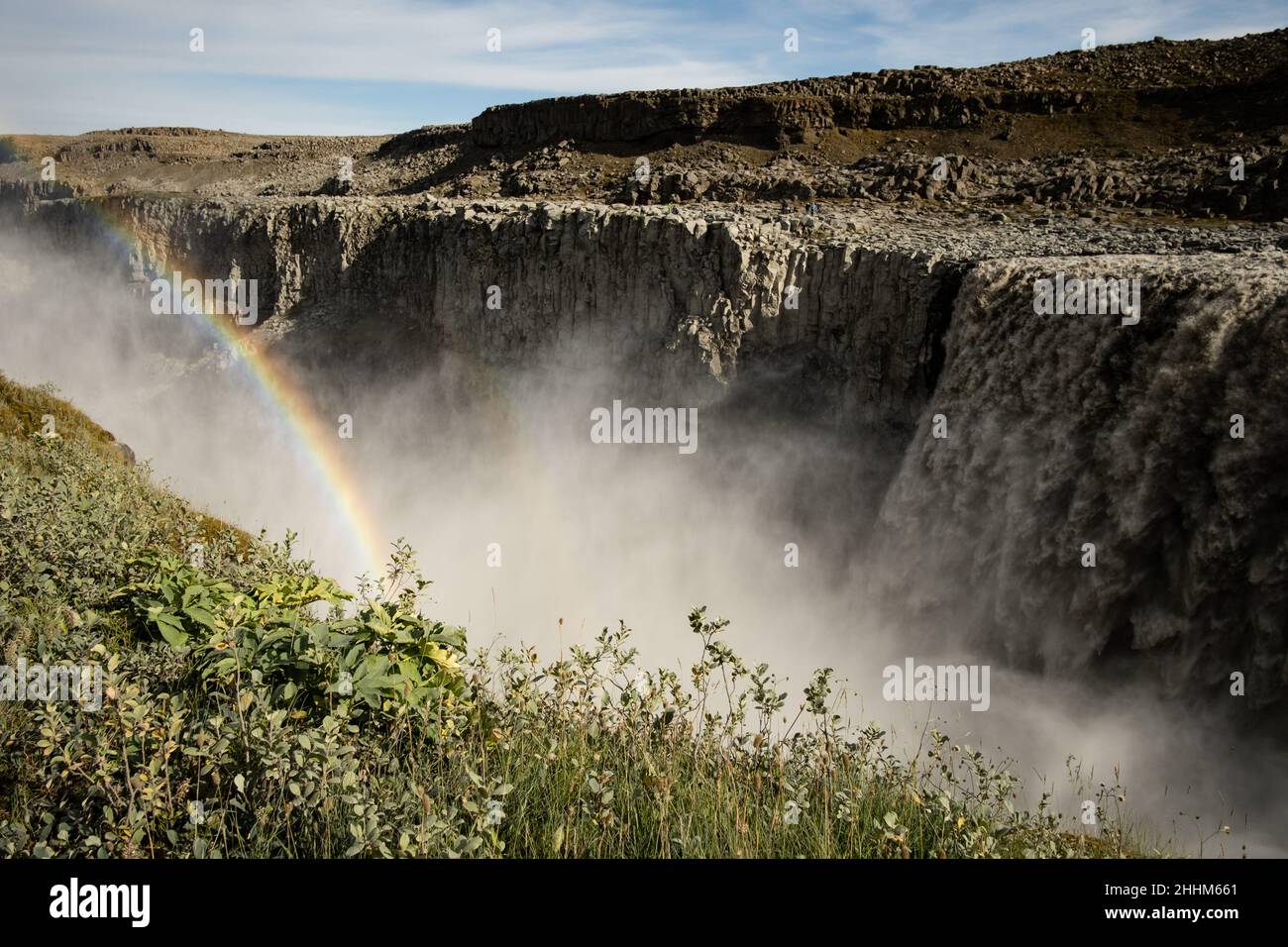 Rainbow and dark gray water of brutal waterfall in Iceland Stock Photo ...