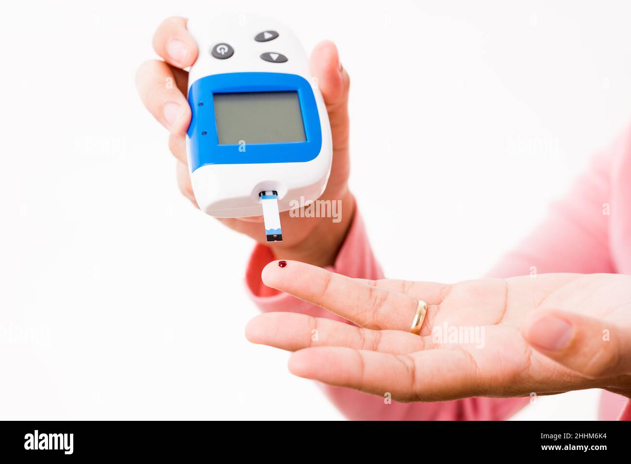 Hands woman measuring glucose test level check with blood on finger by ...