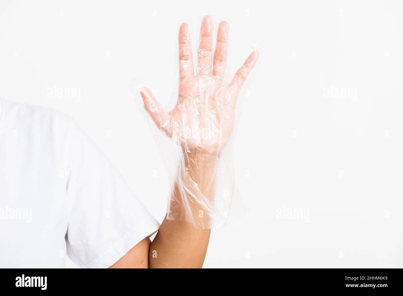 Woman hand wearing single use protect disposable transparent plastic ...