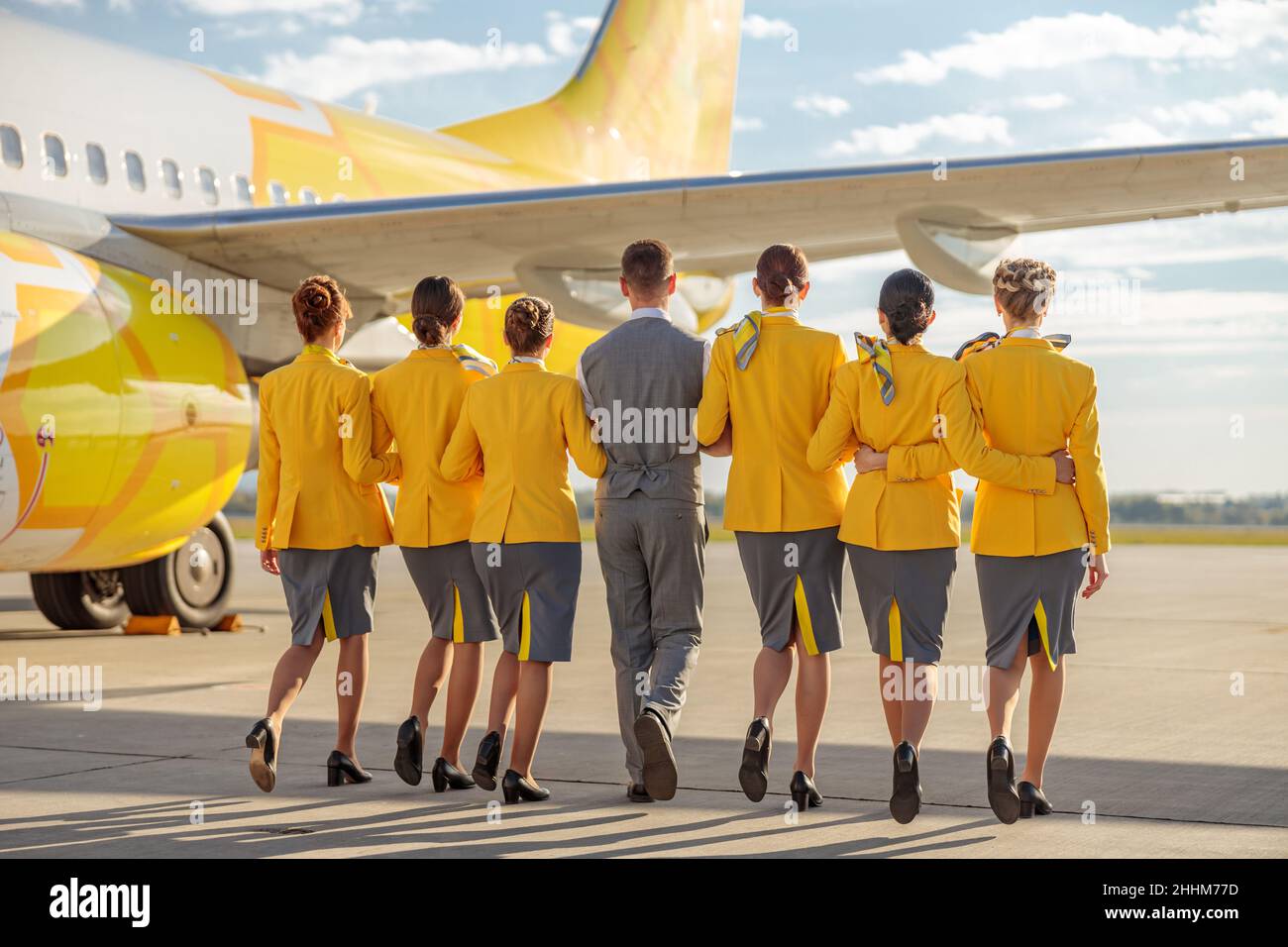 Back view of man and women flight attendants wearing aviation uniform ...