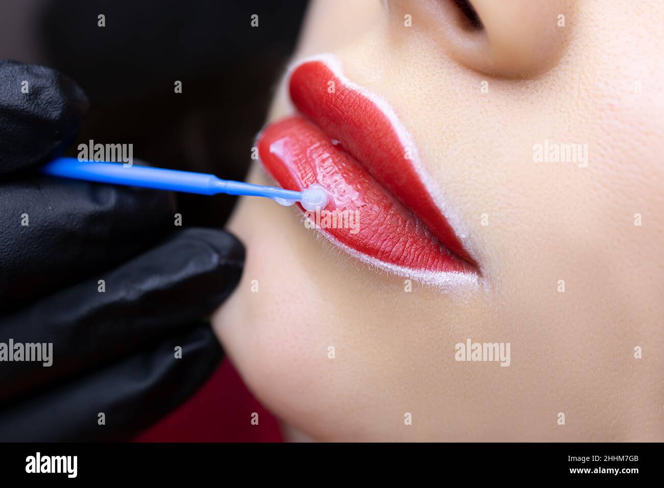 permanent lip tattooing procedure the master applies anesthesia to the ...
