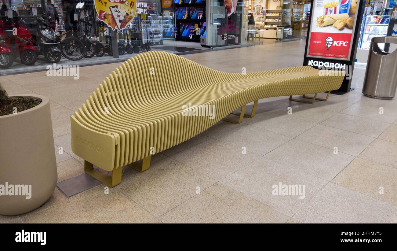 Wooden bench and trash can in the shopping mall. Recreation area in the ...
