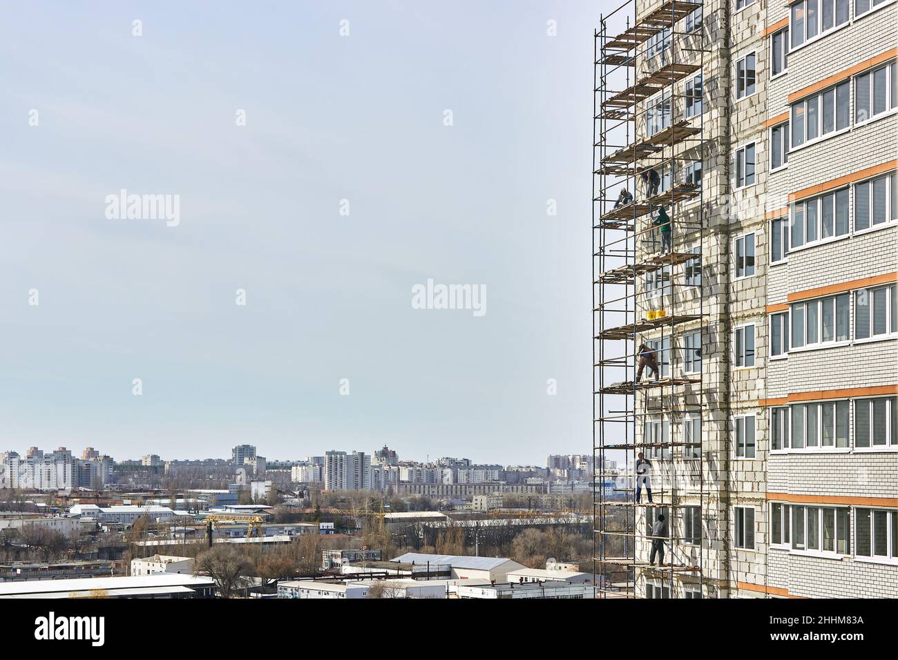 Installation of scaffolding. Builders work without means of protection ...
