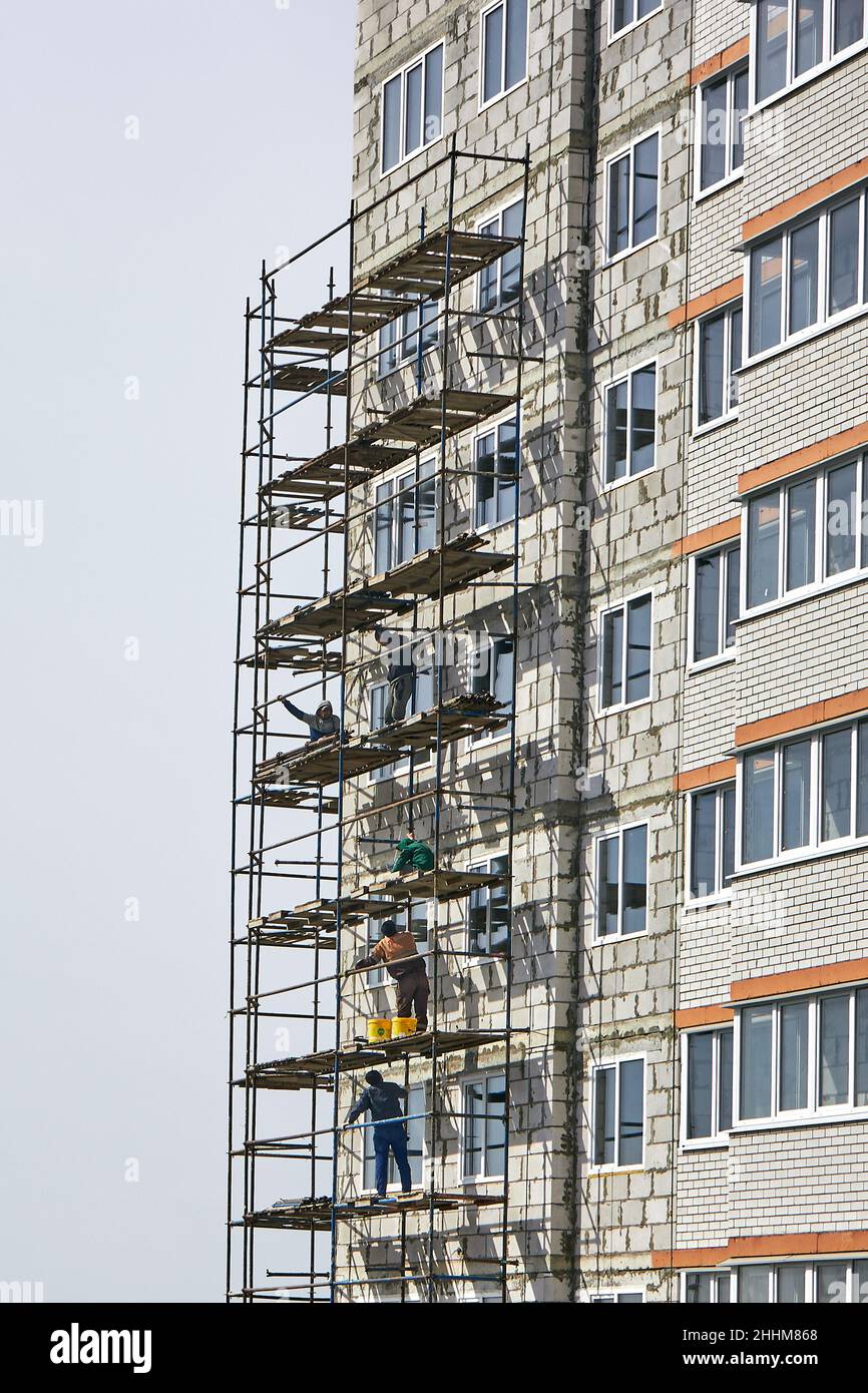 Installation of scaffolding. Builders work without means of protection ... Installation of scaffolding. Builders work without means of protection ...