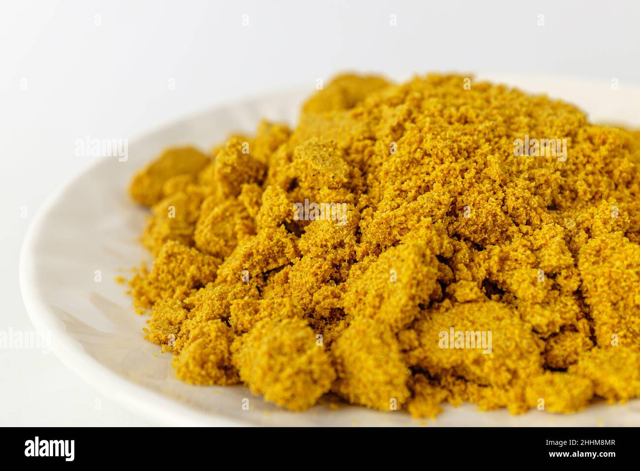 Curry powder on a white background Stock Photo - Alamy