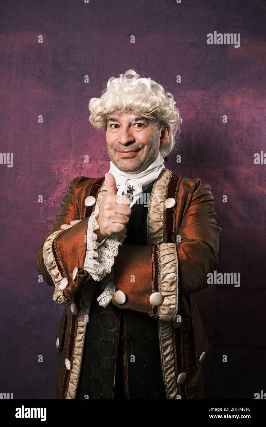 Adult man in classical medieval clothing showing thumb up while ...