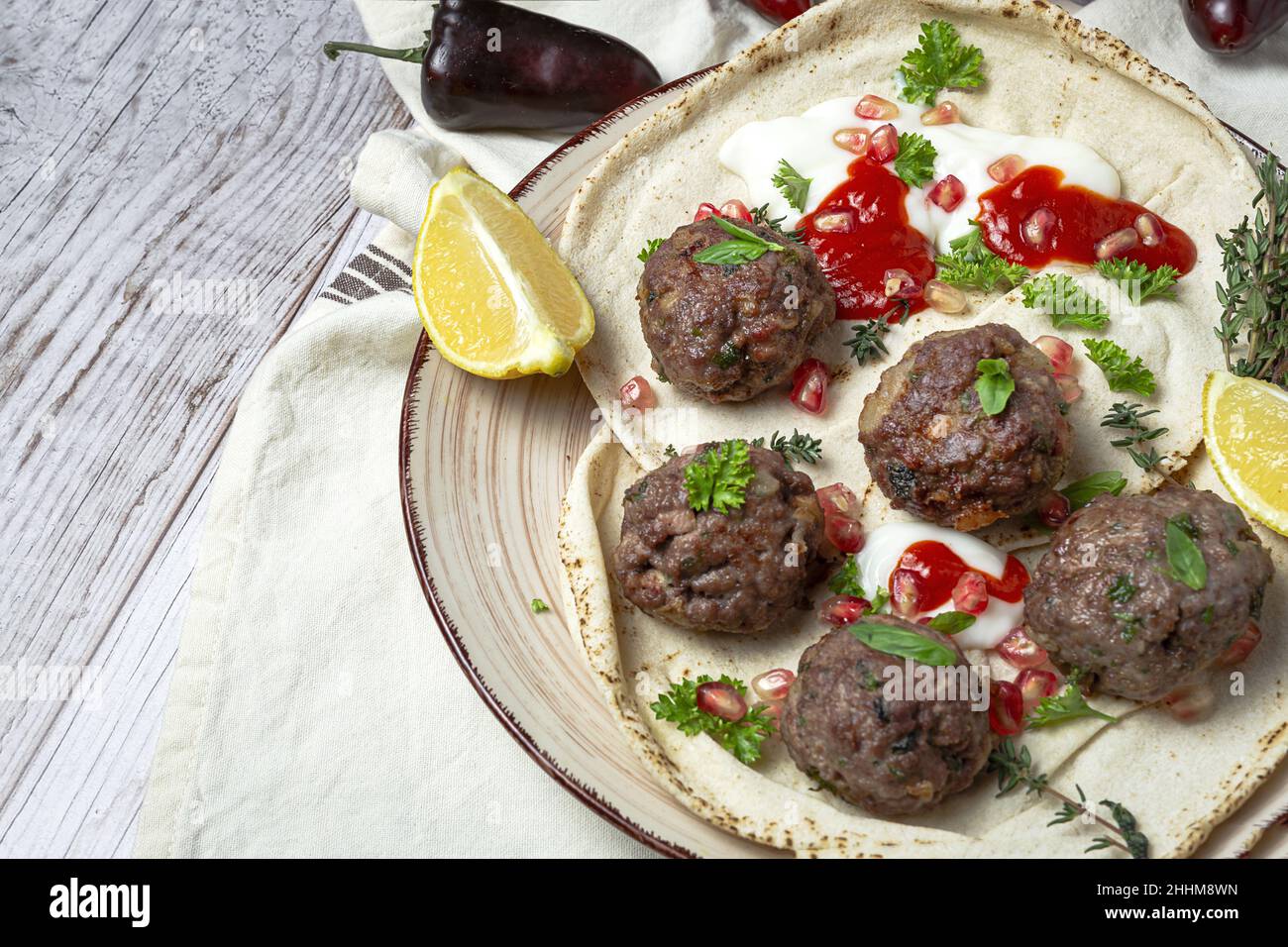 Traditional homemade beef and lamb meatballs with arabic bread, tomato ...