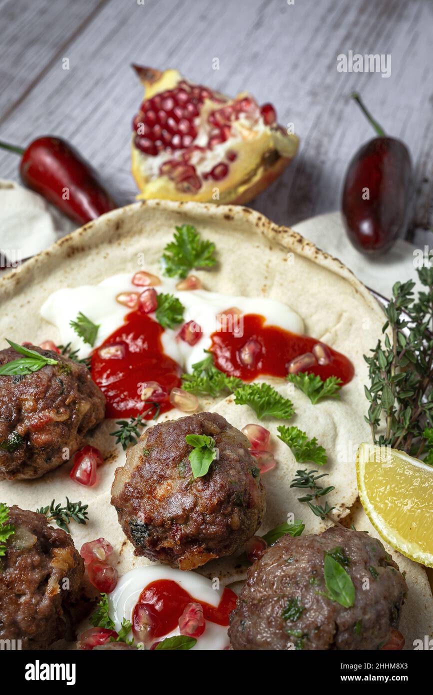 Traditional homemade beef and lamb meatballs with arabic bread, tomato ...