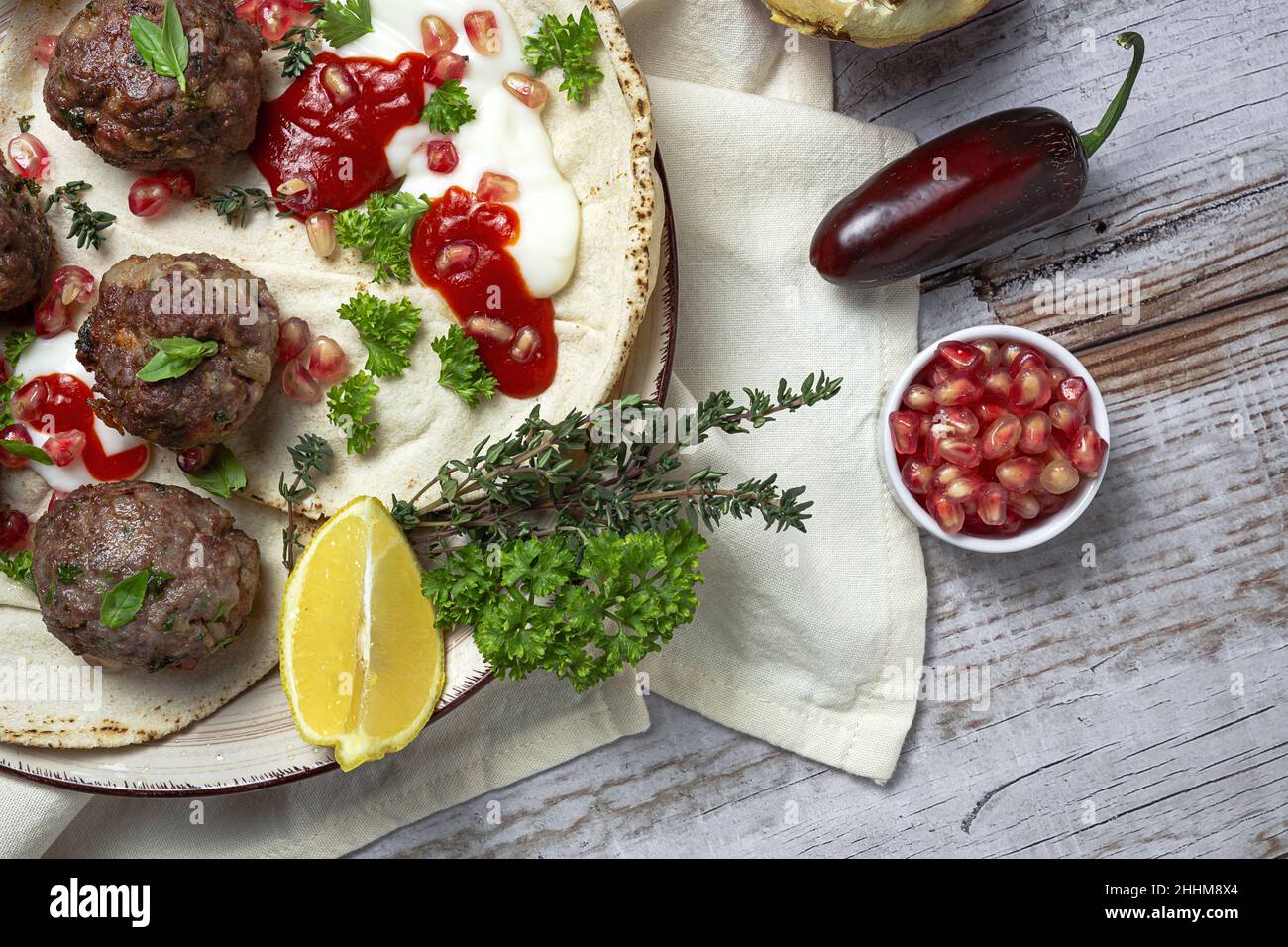 Traditional homemade beef and lamb meatballs with arabic bread, tomato ...