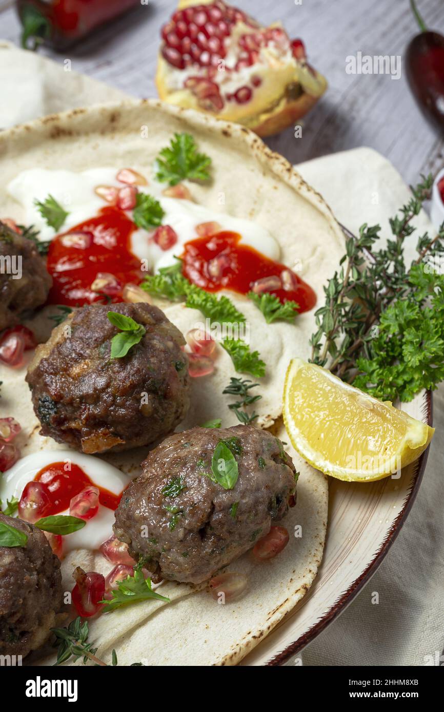 Traditional homemade beef and lamb meatballs with arabic bread, tomato ...