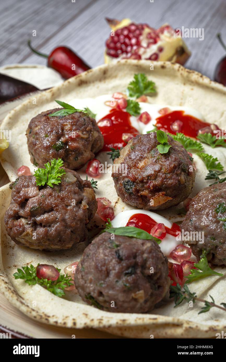Traditional homemade beef and lamb meatballs with arabic bread, tomato ...