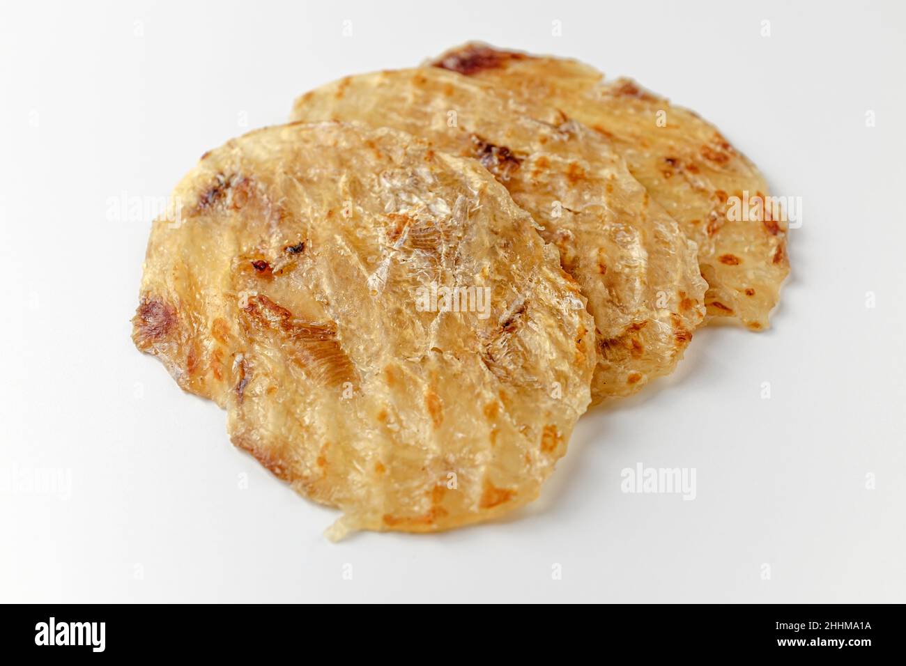 Dried filefish fillet on white background Stock Photo - Alamy