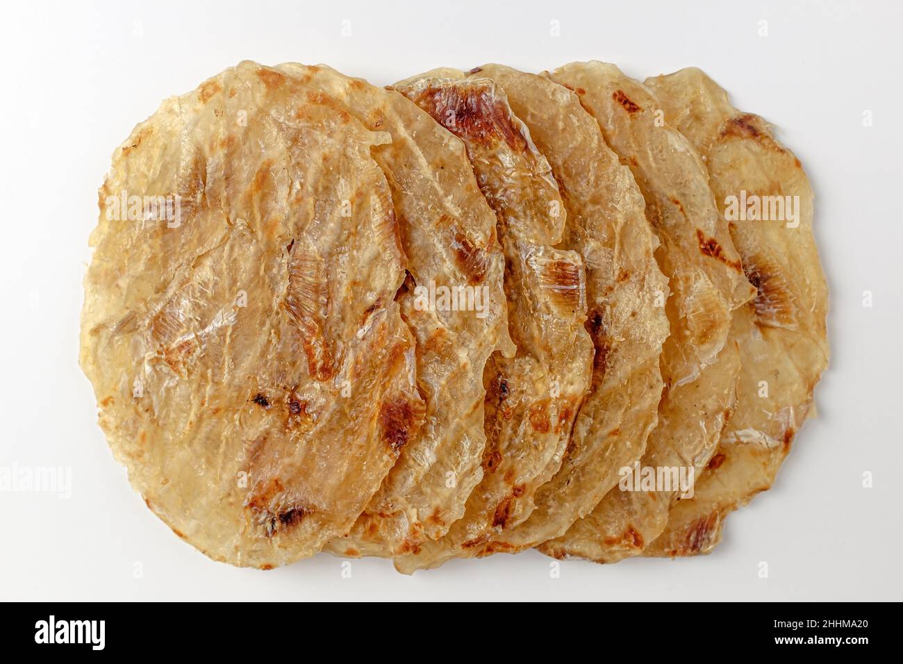 Dried filefish fillet on white background Stock Photo - Alamy