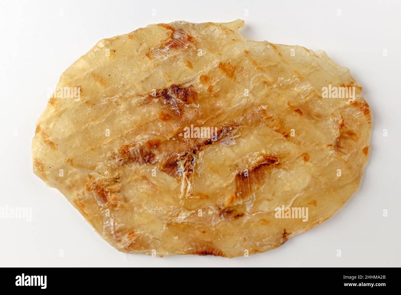 Dried filefish fillet on white background Stock Photo - Alamy