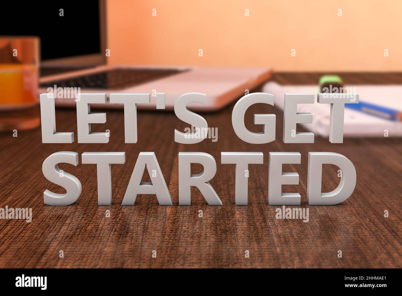 Lets get started - letters on wooden desk with laptop computer and a ...