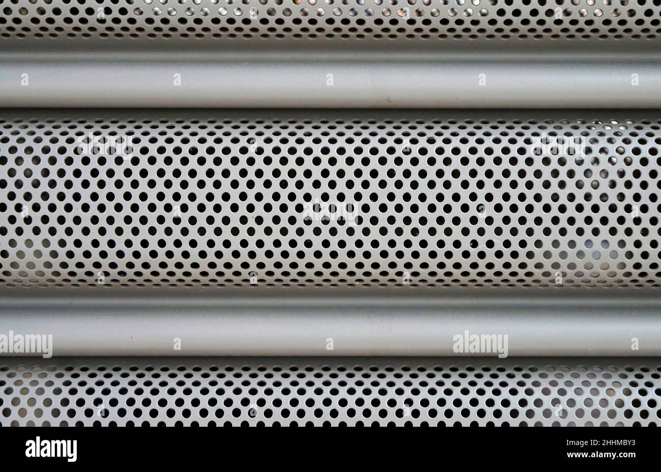 Perforated metallic surface texture background Stock Photo - Alamy