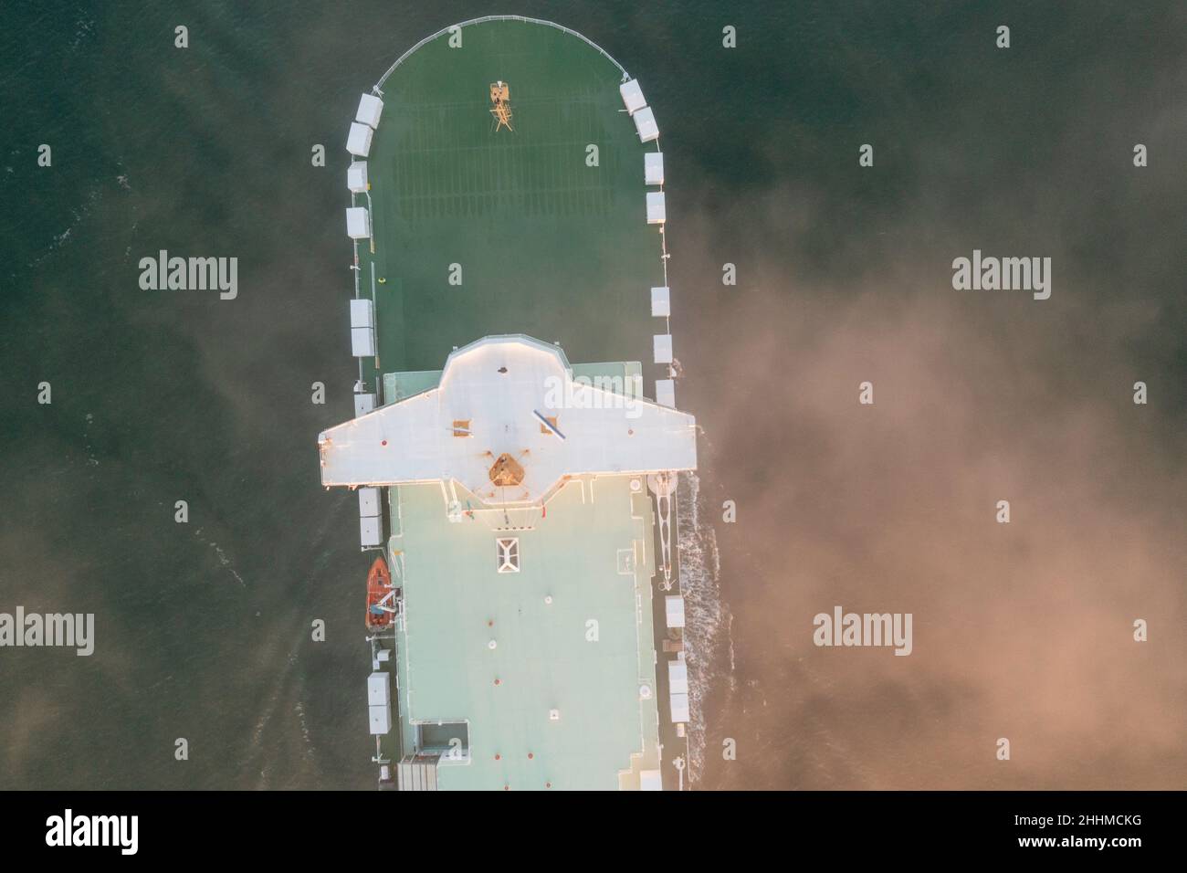 top-down shot of a roro vehicle carrier early morning with fog ...