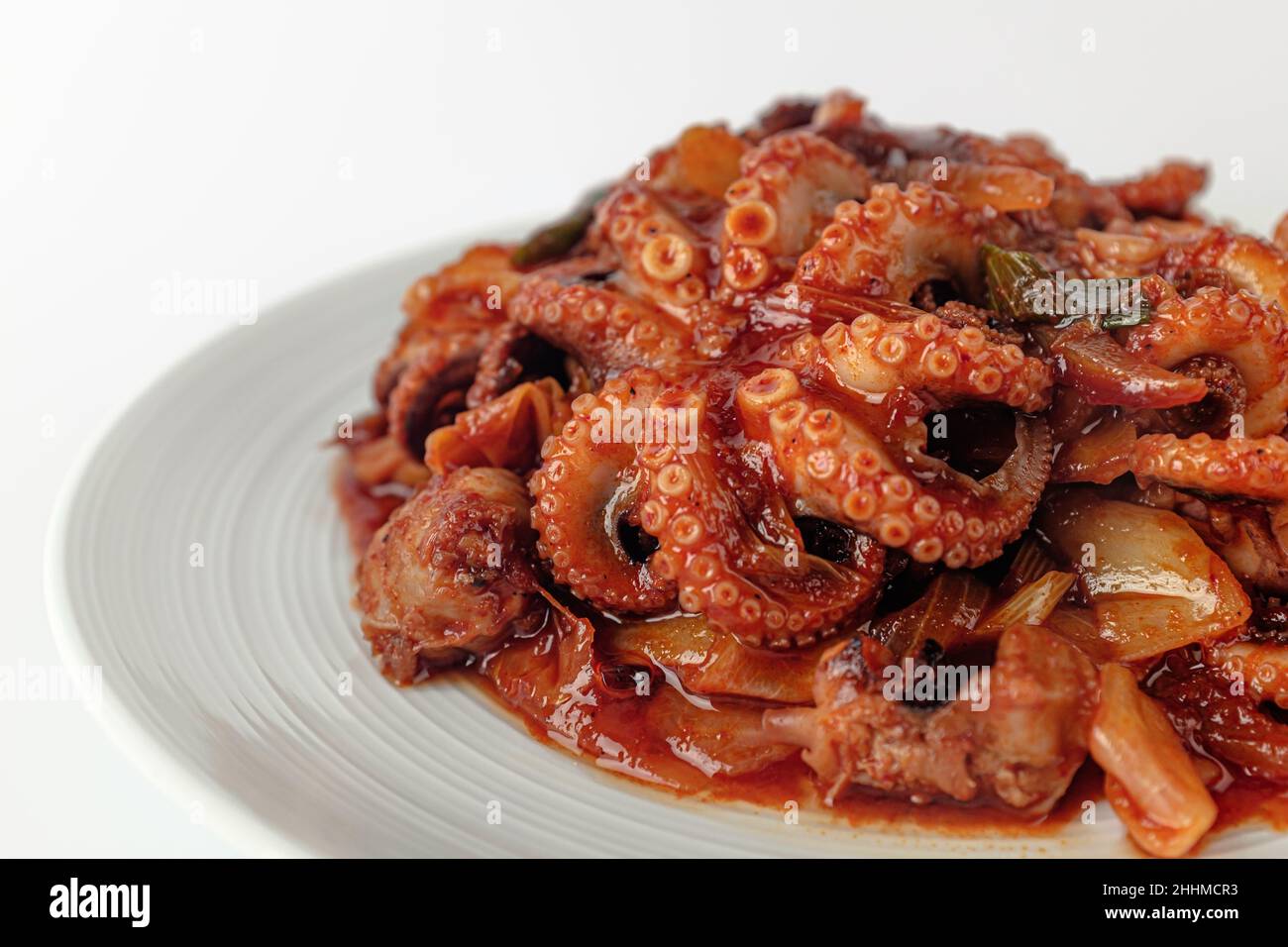 Stir-fried Webfoot octopus on a white background Stock Photo - Alamy