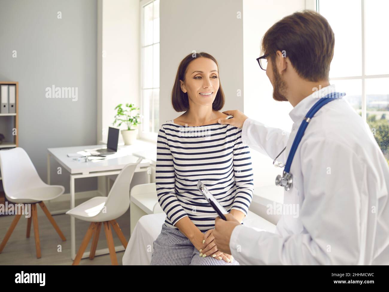 Doctor Touches Patients Shoulder For Encouragement Empathy And