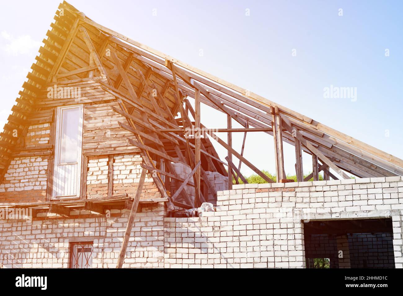 unfinished construction and building of a brick diy house with a wooden ...