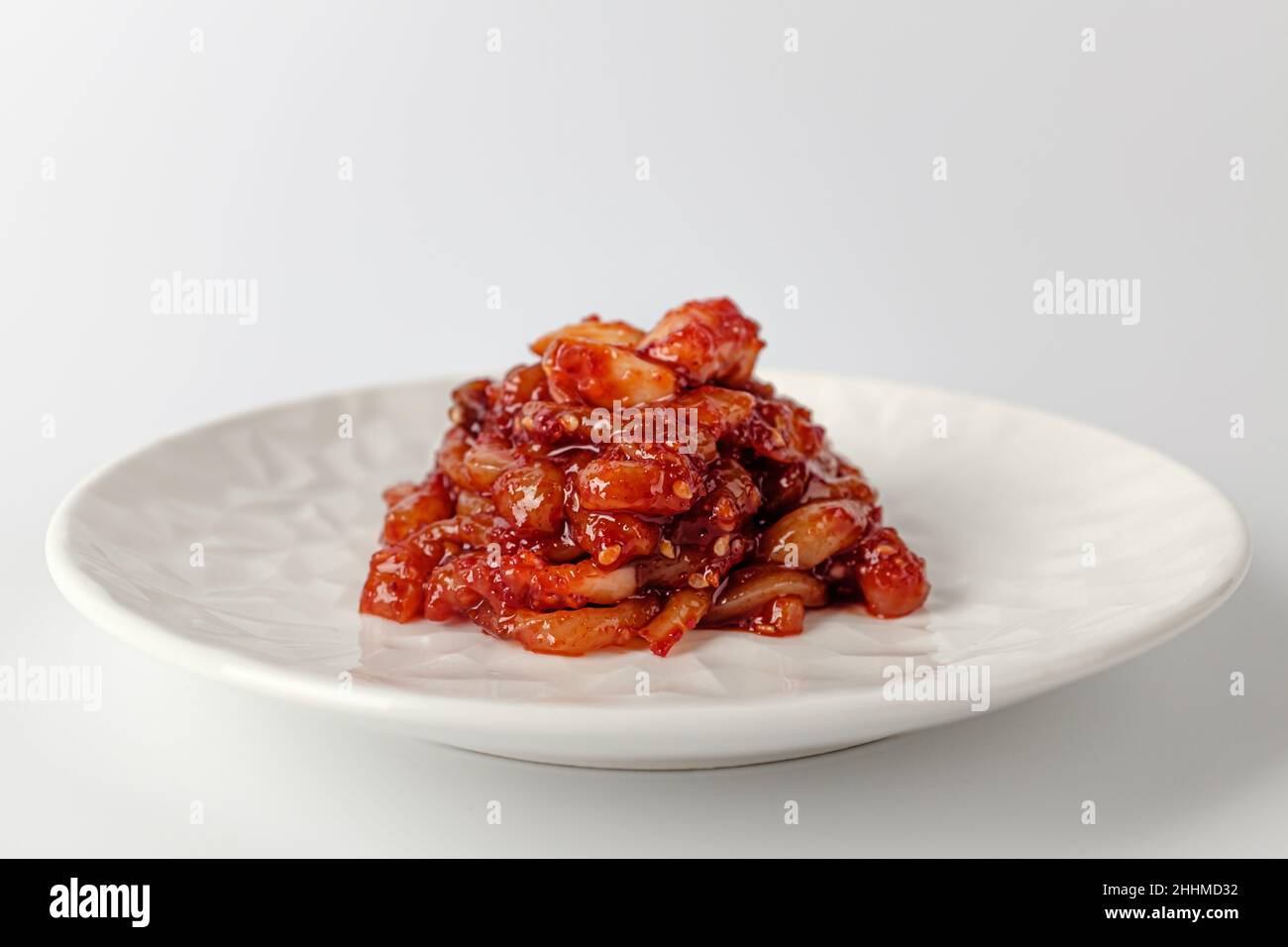 pickled squid on a white background Stock Photo - Alamy