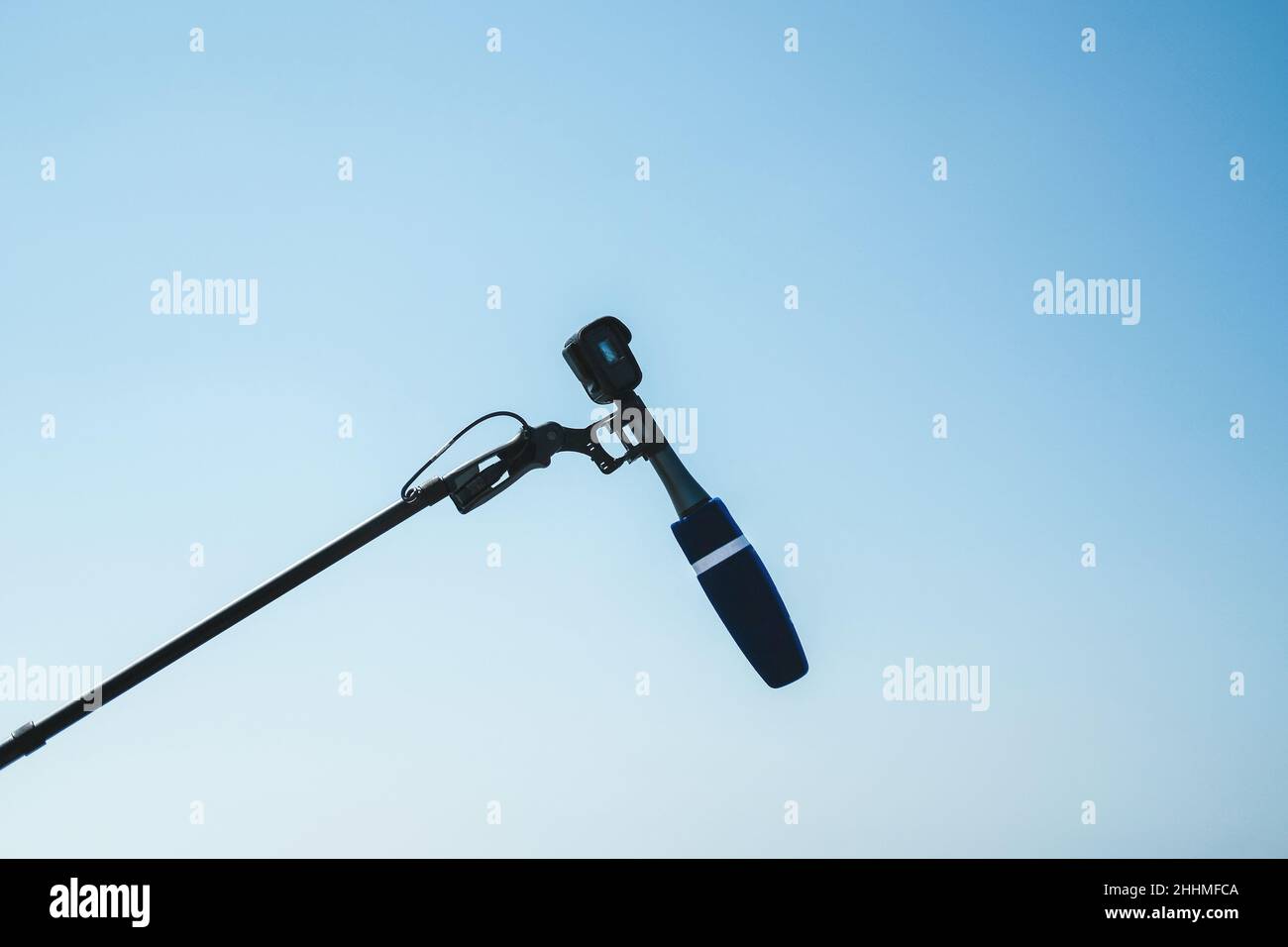 An airplane flying in the sky and a microphone on a tripod. Airplane ...