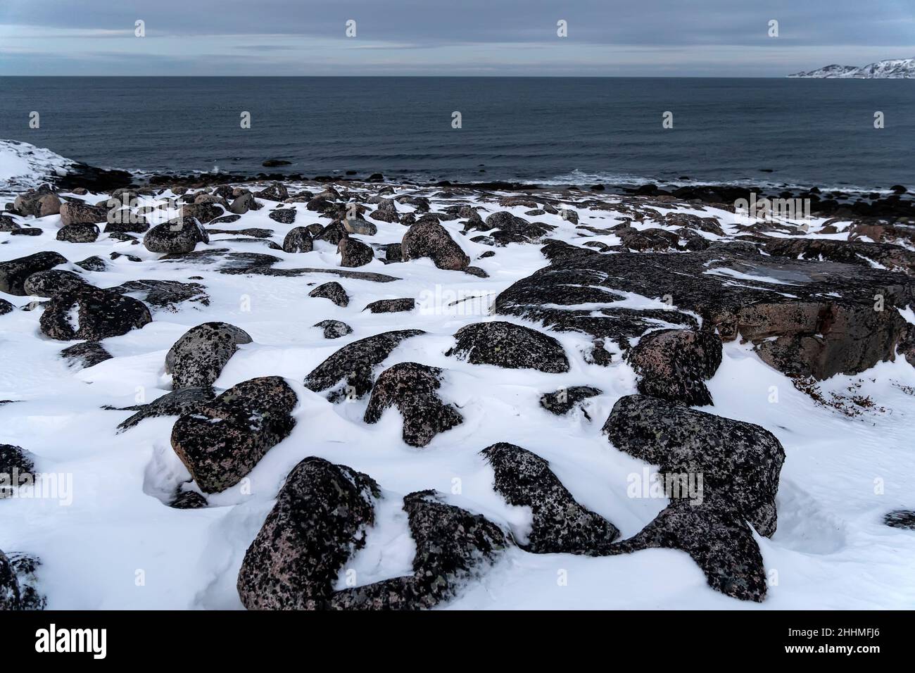 Winter landscape with snow-covered rocks. Arctic Ocean. Round large ...