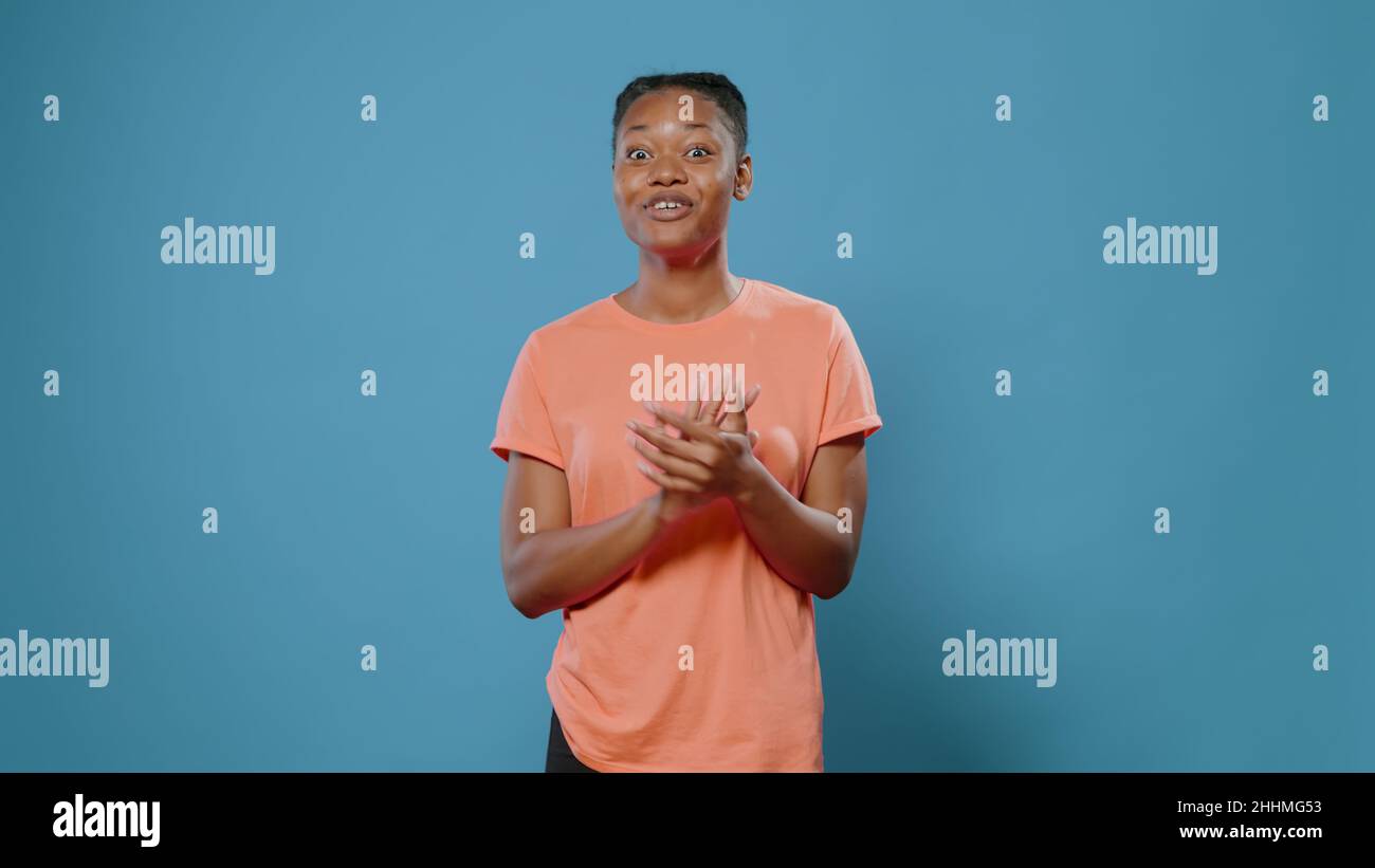 Cheerful person clapping hands and cheering success in studio. Grateful ...