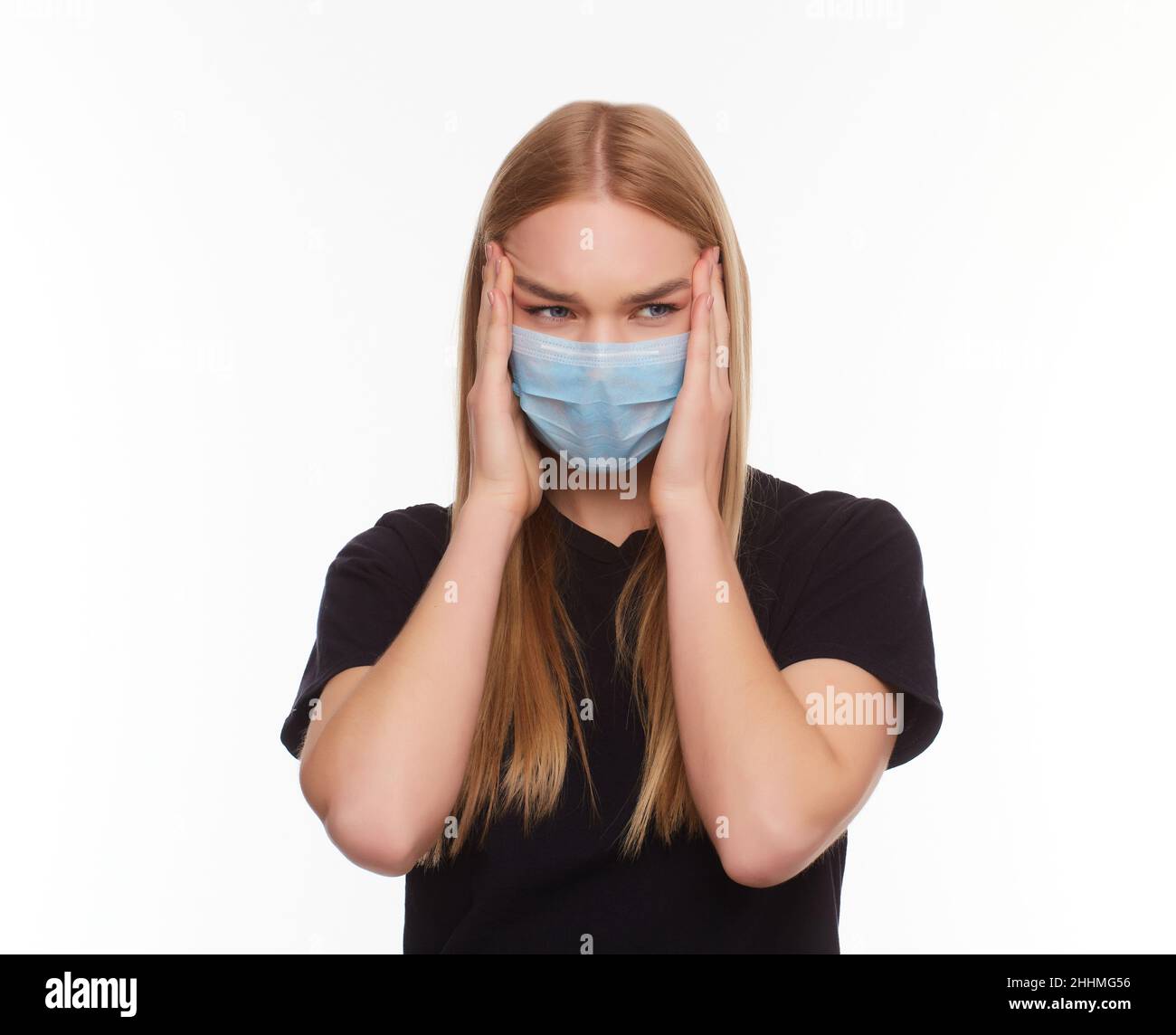 Studio portrait of young blonde illness girl with closed eyes, wearing ...