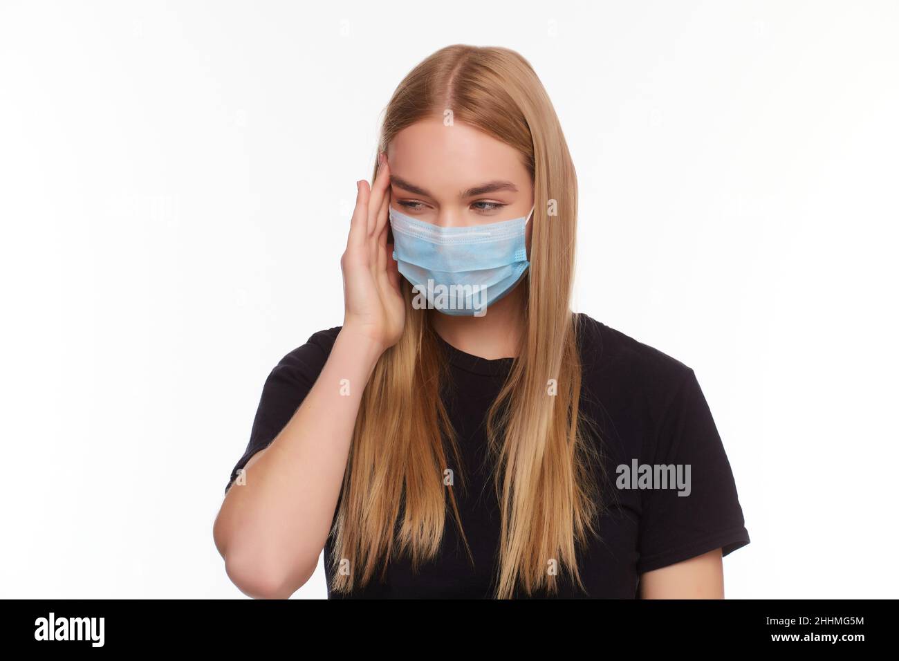 Studio portrait of young blonde illness girl with closed eyes, wearing ...
