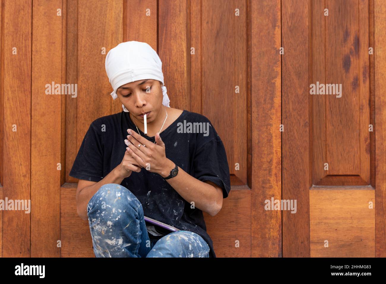 Construction worker woman on a break smoking a cigarette Stock Photo ...