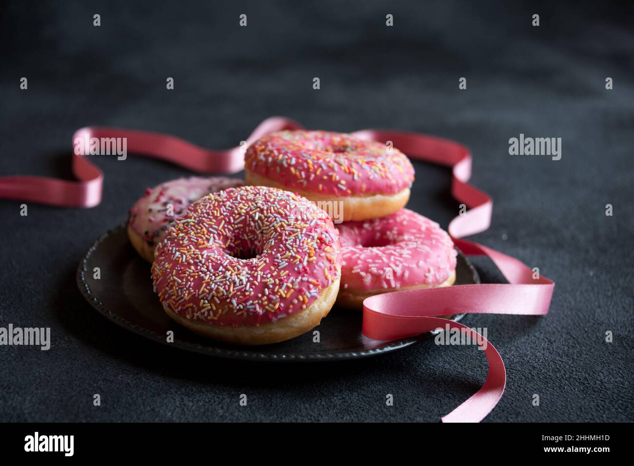 Bright pink donuts, delicious dessert Stock Photo - Alamy