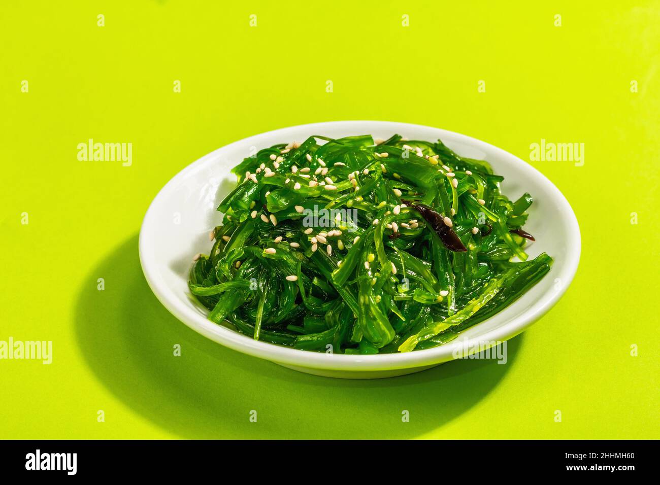 Chuka Seaweed Salad with sesame seeds and nut sauce. Trendy hard light, dark shadow. Sunny green ...