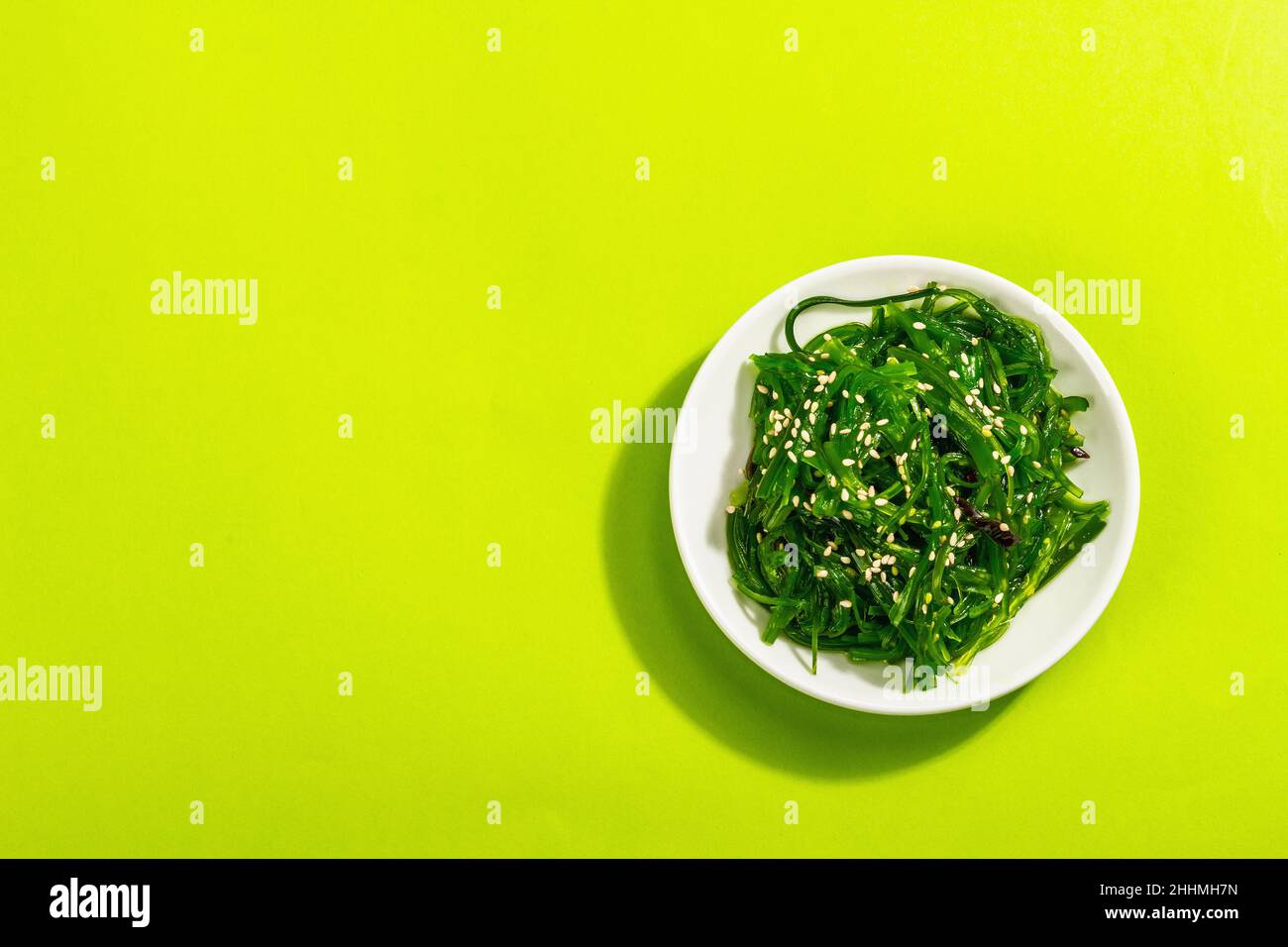 Chuka Seaweed Salad with sesame seeds and nut sauce. Trendy hard light, dark shadow. Sunny green ...