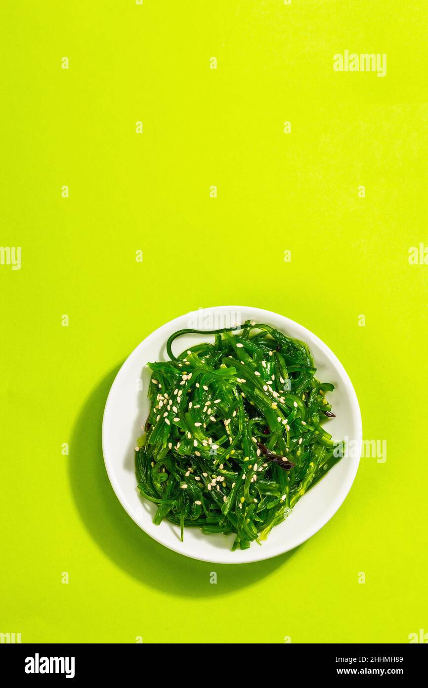 Chuka Seaweed Salad with sesame seeds and nut sauce. Trendy hard light, dark shadow. Sunny green ...