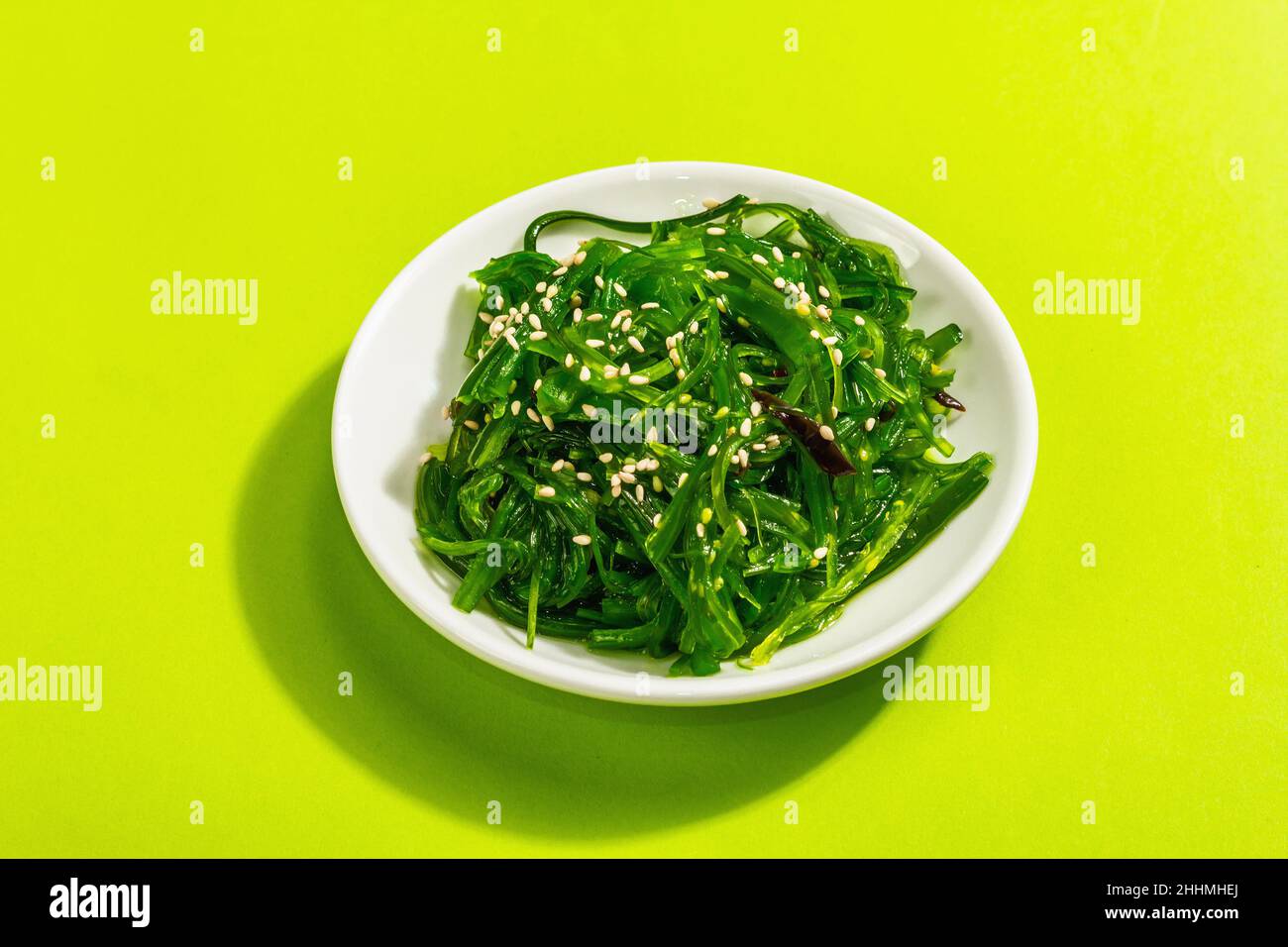 Chuka Seaweed Salad with sesame seeds and nut sauce. Trendy hard light, dark shadow. Sunny green ...