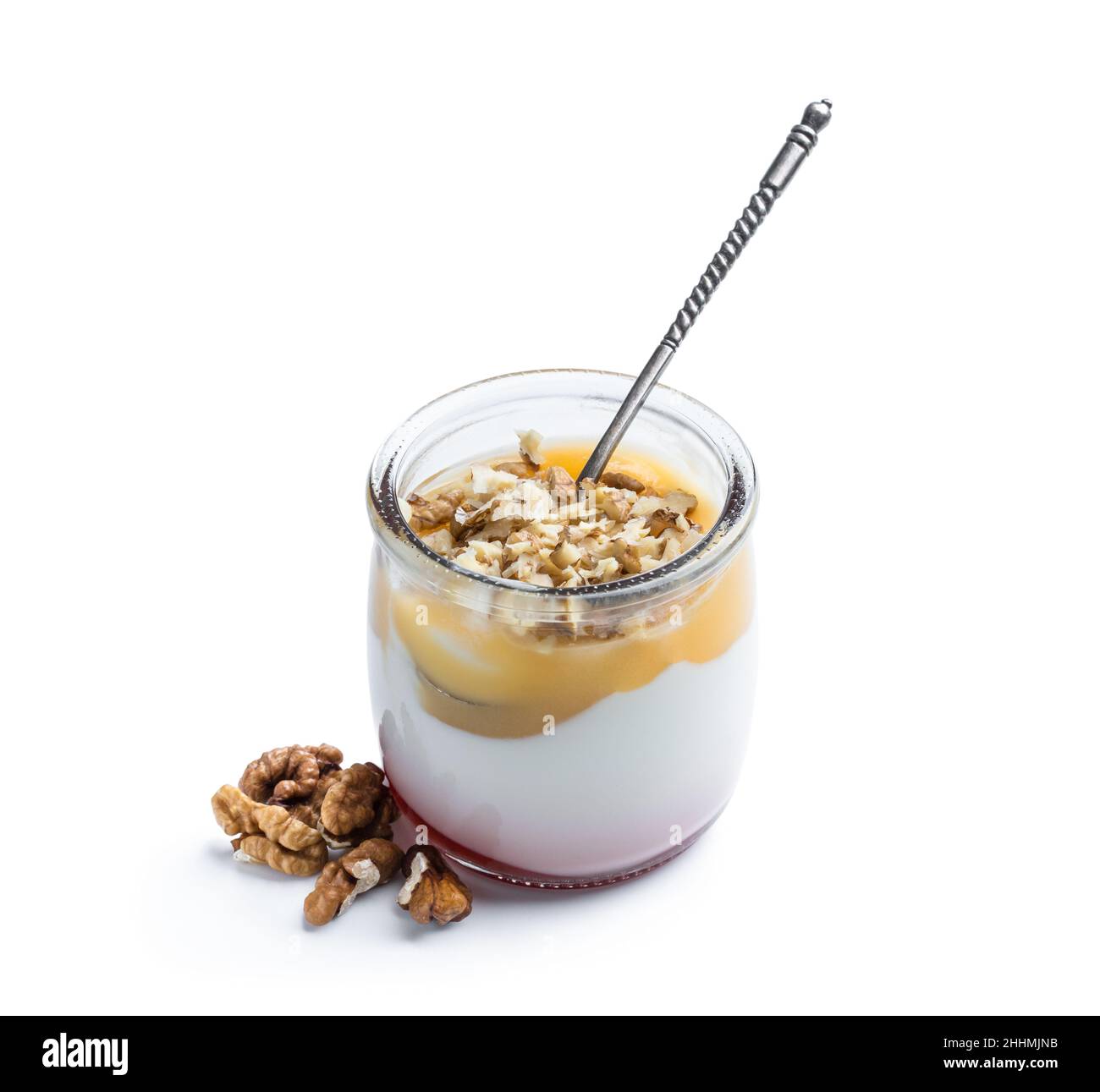 White creamy yogurt with yellow fruitty puree and walnut in small jar ...