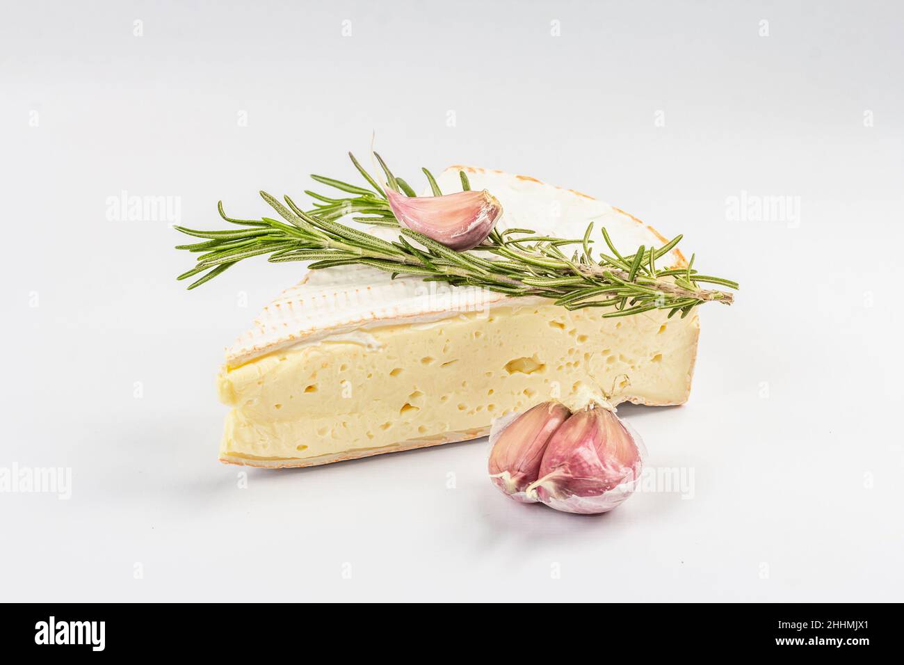 Rougette cheese with fresh rosemary and garlic isolated on white ...