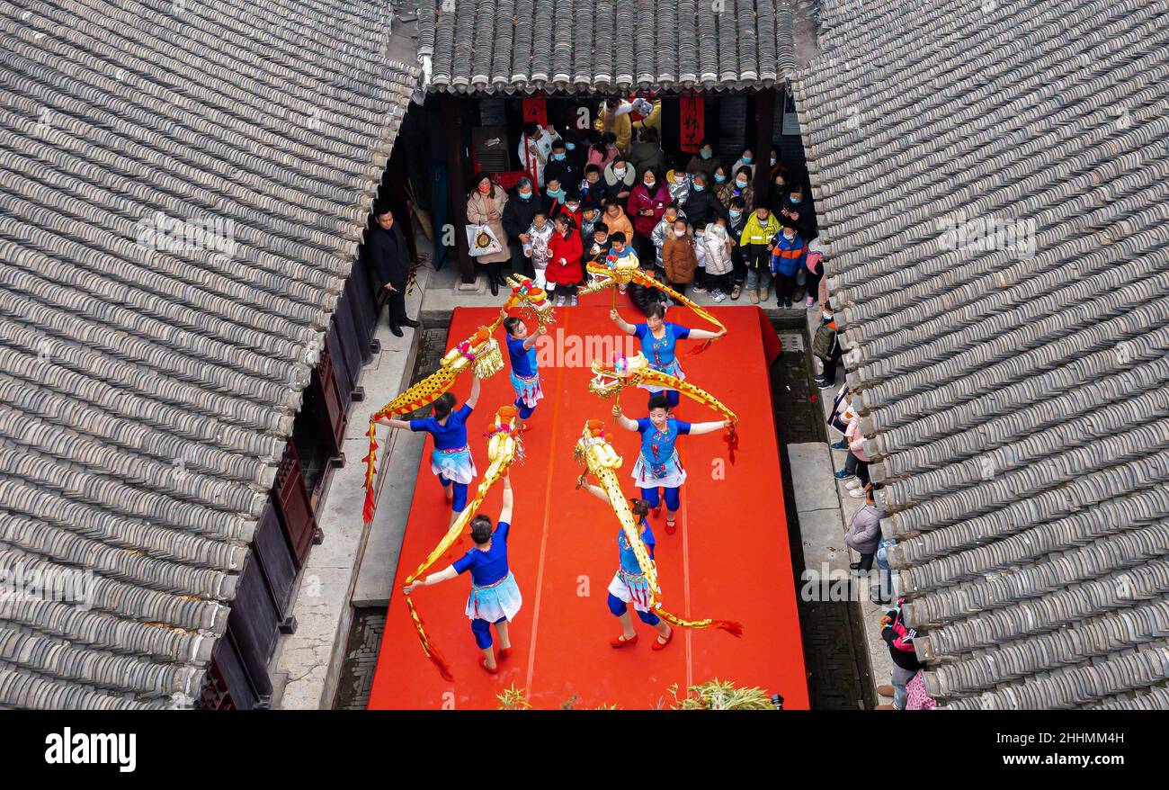 HAIAN, CHINA - JANUARY 25, 2022 - People watch a dragon dance ...