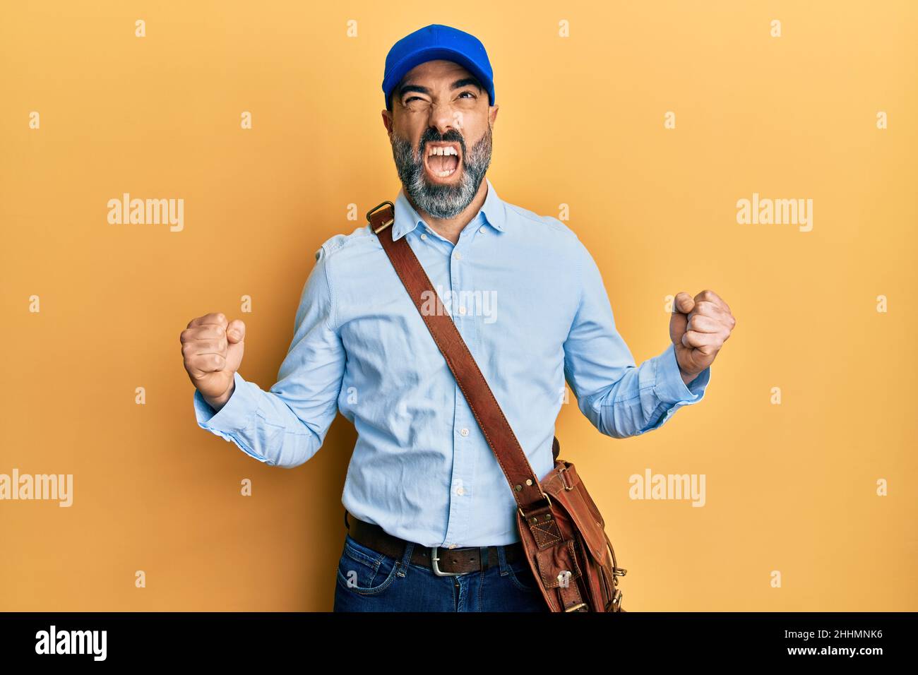 Middle age man with beard and grey hair wearing delivery courier cap ...