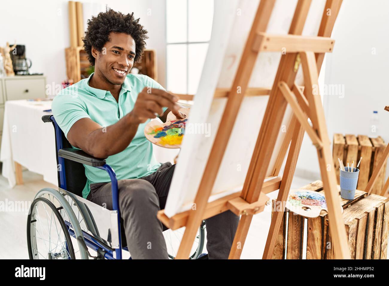 Young african american disabled artist man sitting on wheelchair ...