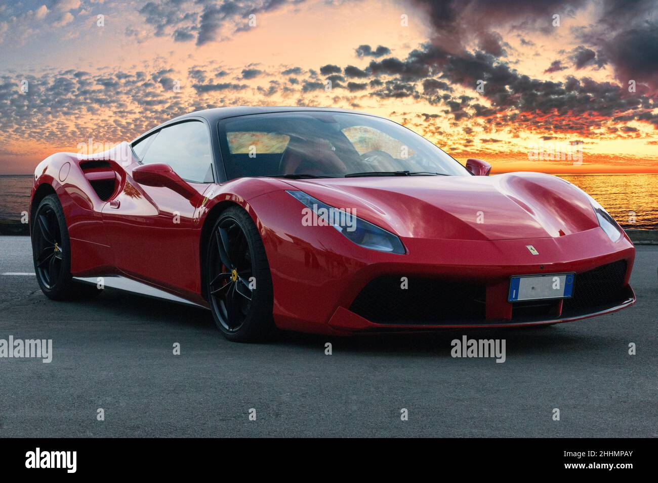 Luxury model sports car Ferrari 488 GTB located in scenic sunset ...