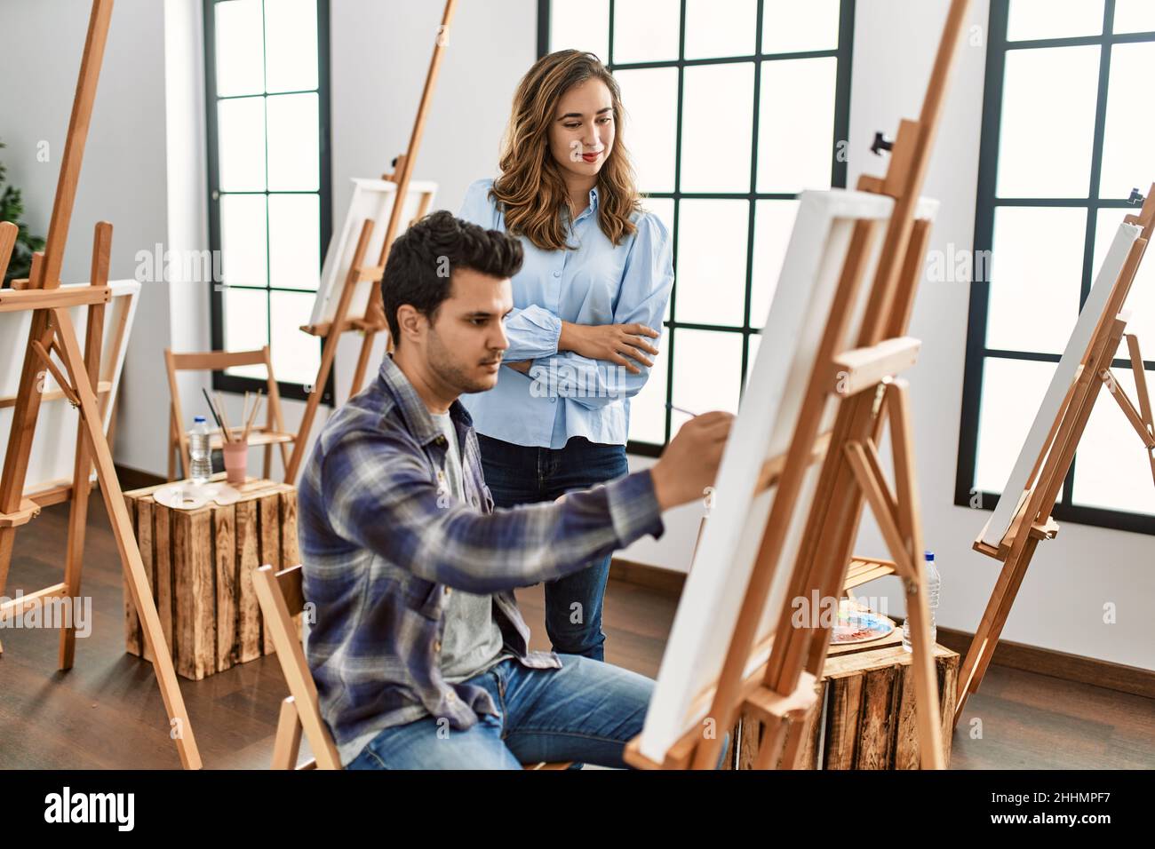 Paint teacher teaching to student at art school Stock Photo - Alamy