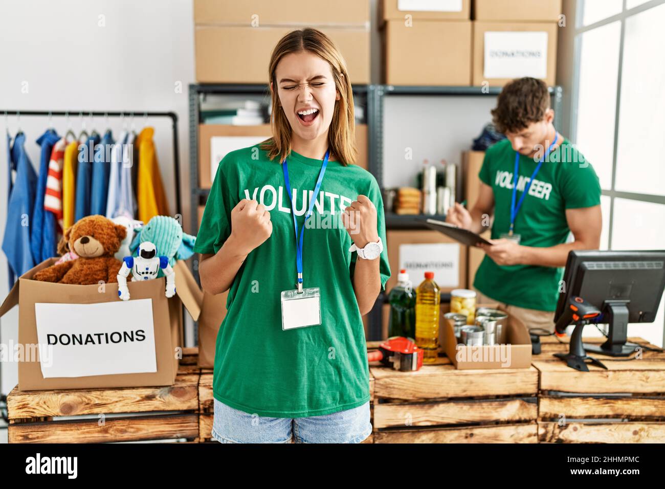 Young blonde girl wearing volunteer t shirt at donation stand very ...