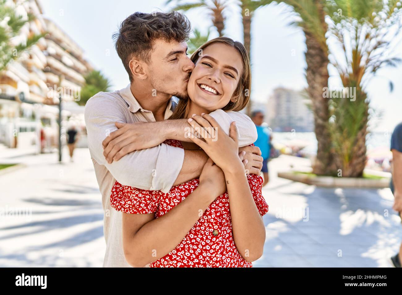 Young hispanic couple smiling happy and hugging standing at the city ...