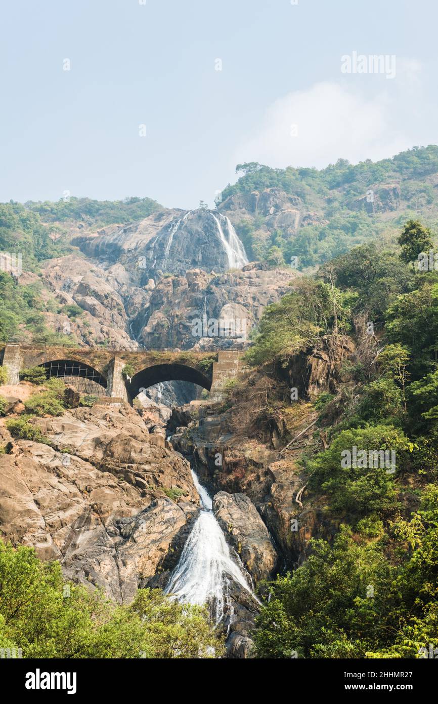 Dudhsagar waterfall and old bridge in Indian state of Goa on a sunny ...
