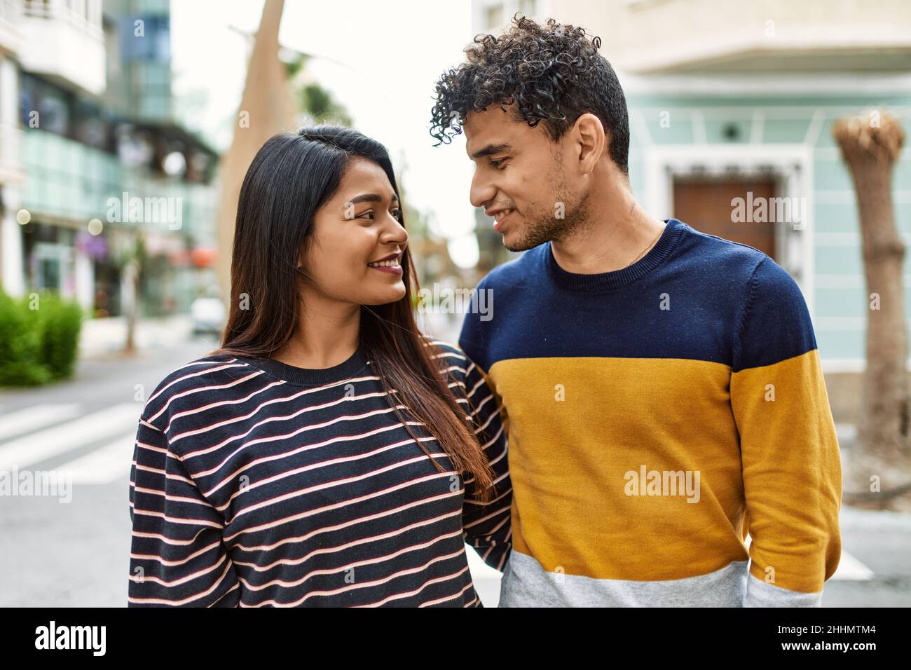 Young latin couple smiling happy and hugging at the city Stock Photo ...