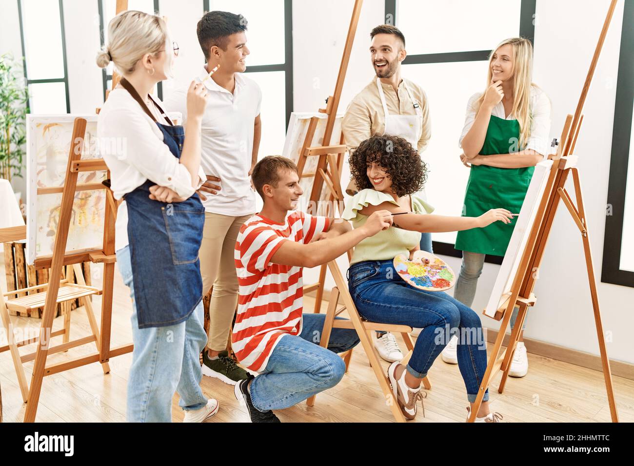 Group of people smiling happy and looking draw of partner at art studio ...