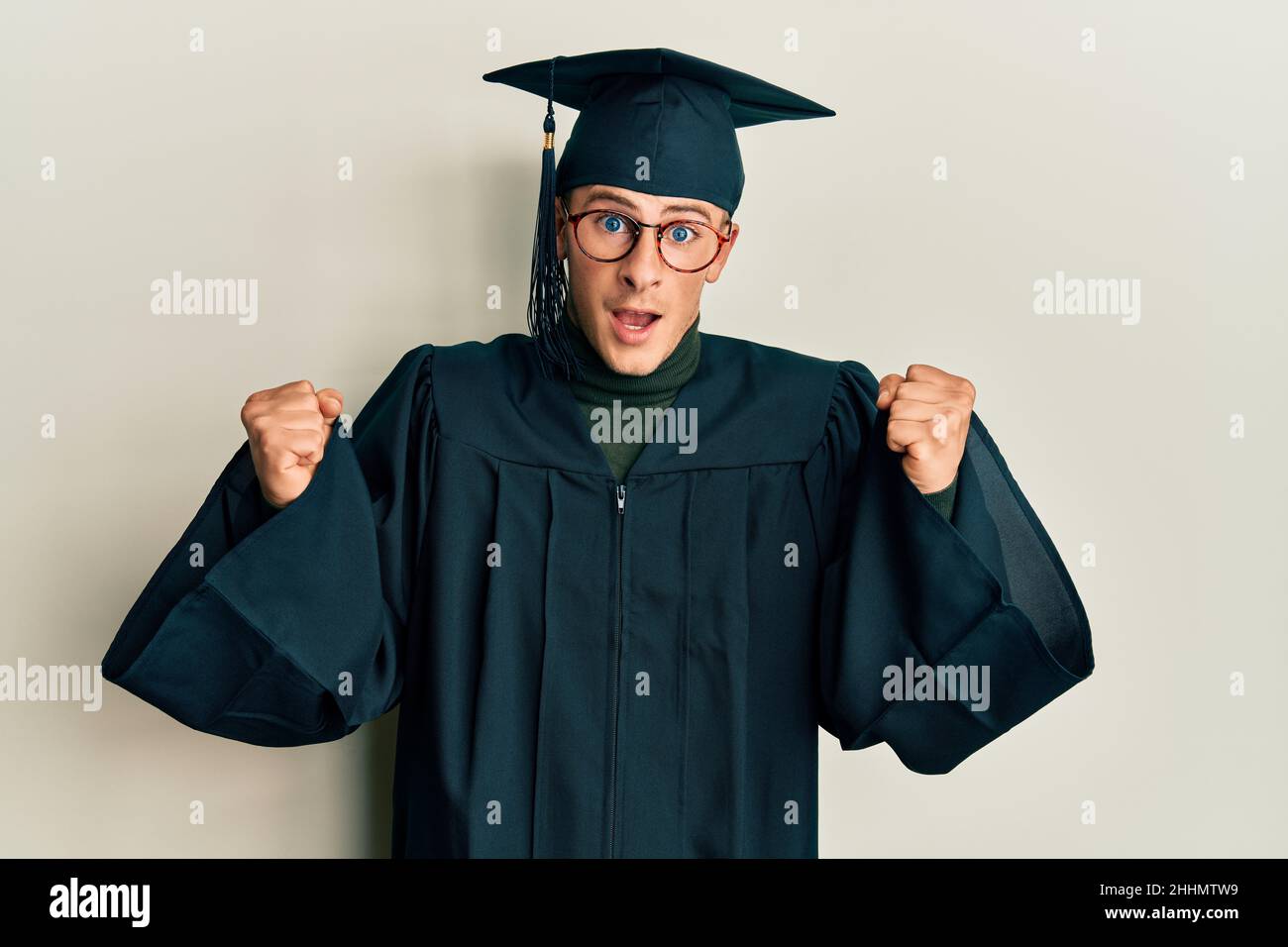 Young caucasian man wearing graduation cap and ceremony robe ...